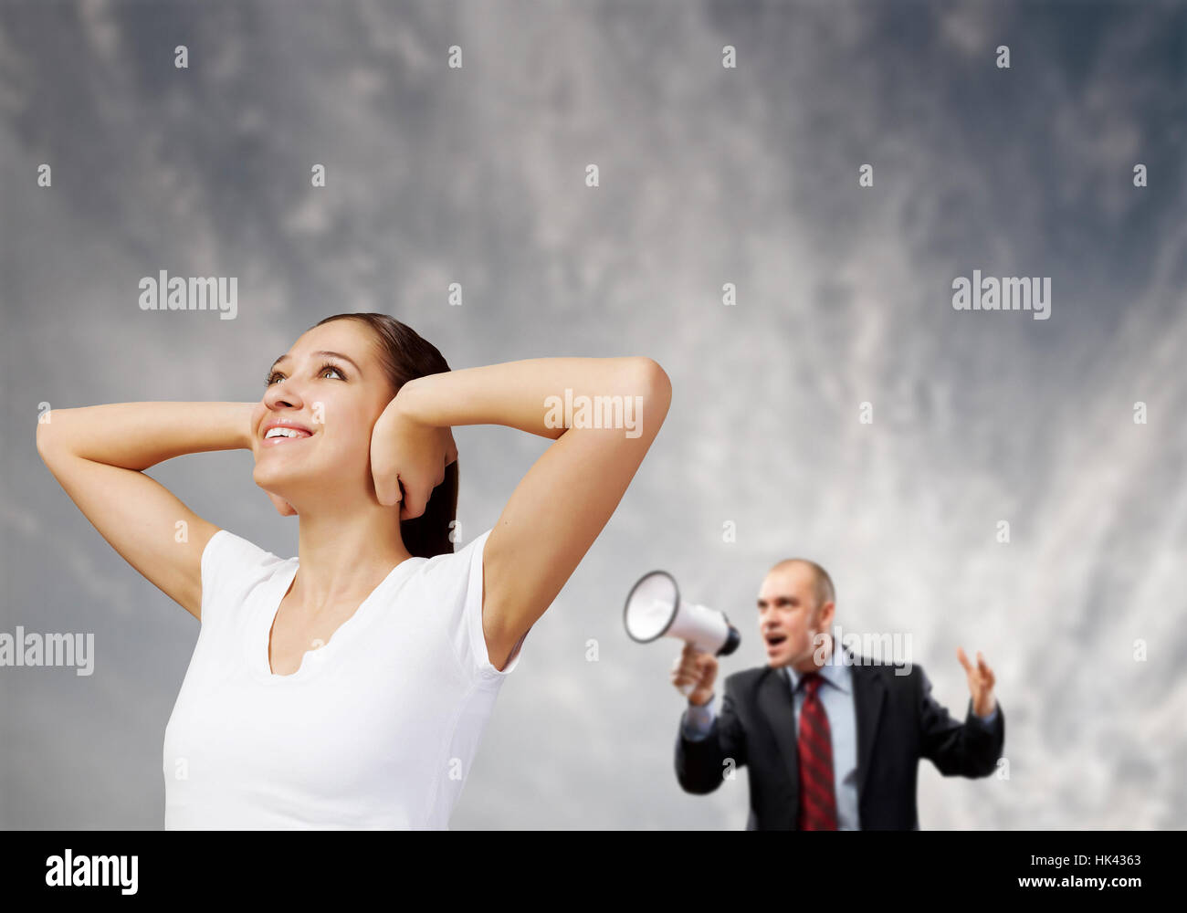 Furious woman screaming agressively in megaphone at woman hi-res stock ...