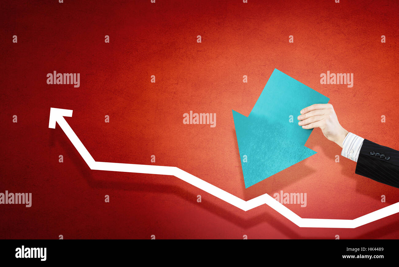 Hand holding arrow representing business growth concept Stock Photo - Alamy