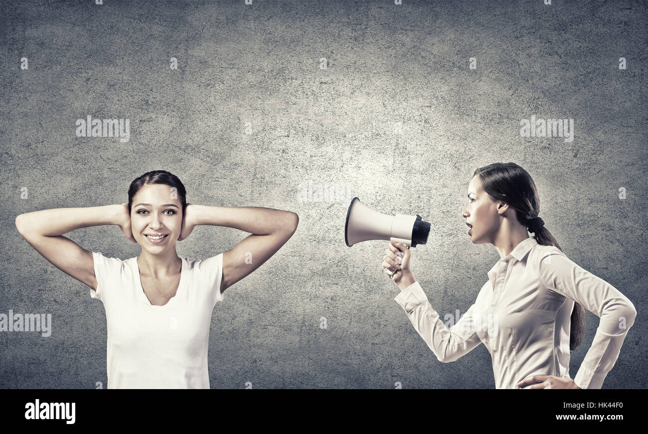 Young furious woman screaming agressively in megaphone Stock Photo - Alamy
