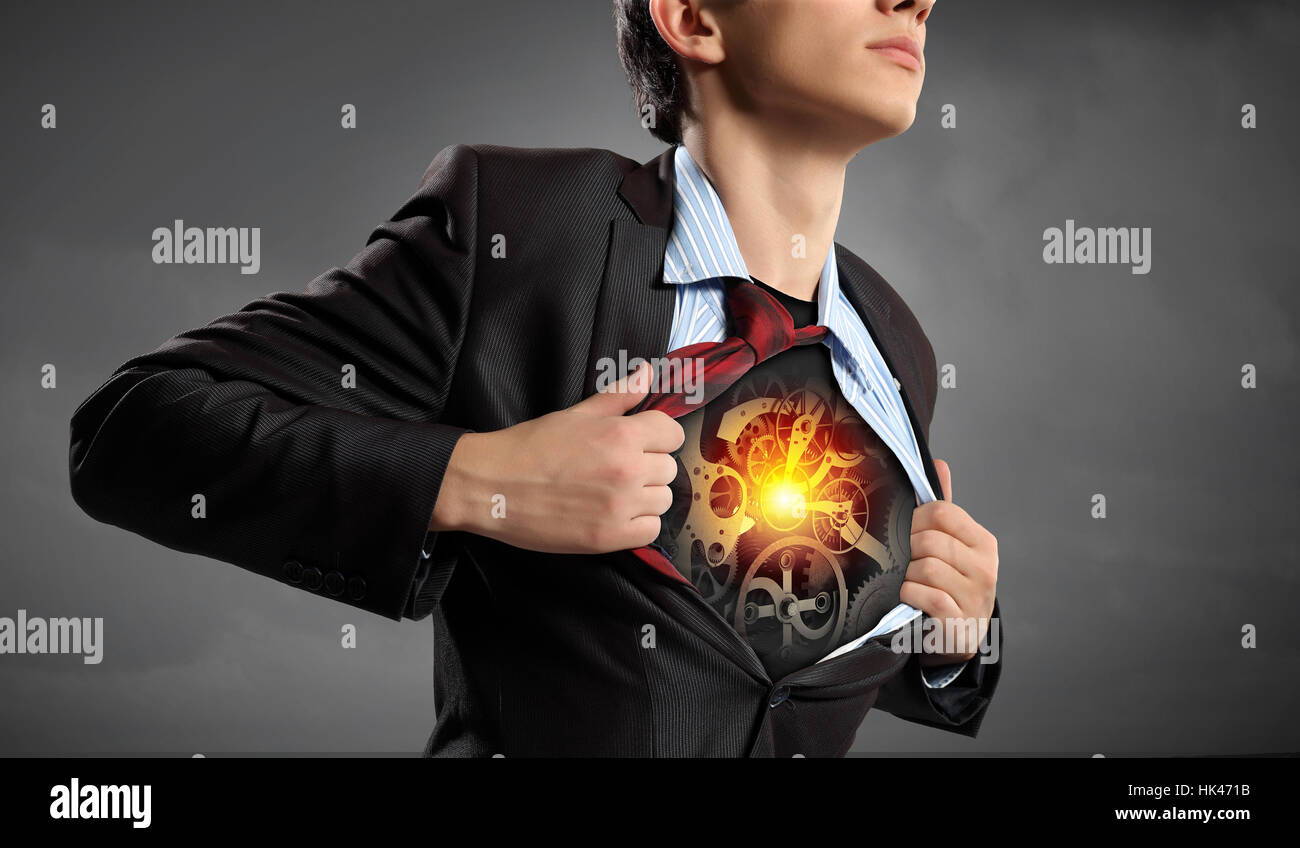 Young businessman opening chest and acting like super hero hi-res stock ...