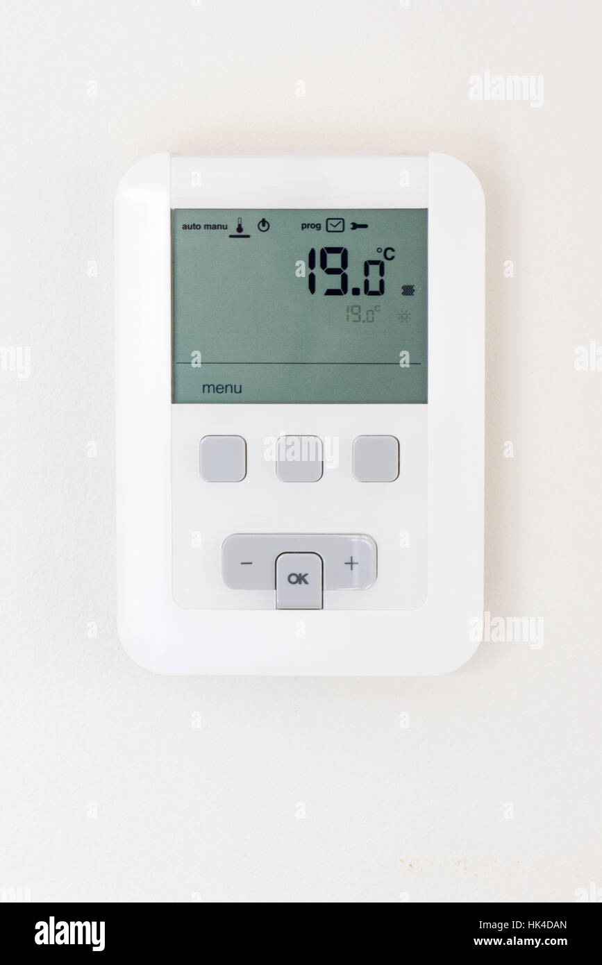 Digital thermostat on white wall Stock Photo - Alamy