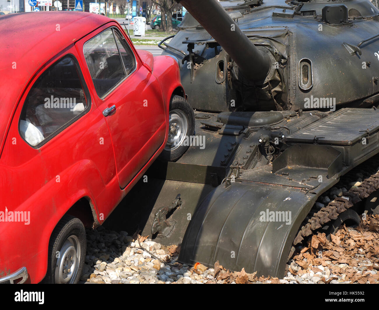 small red car running over tank Stock Photo - Alamy