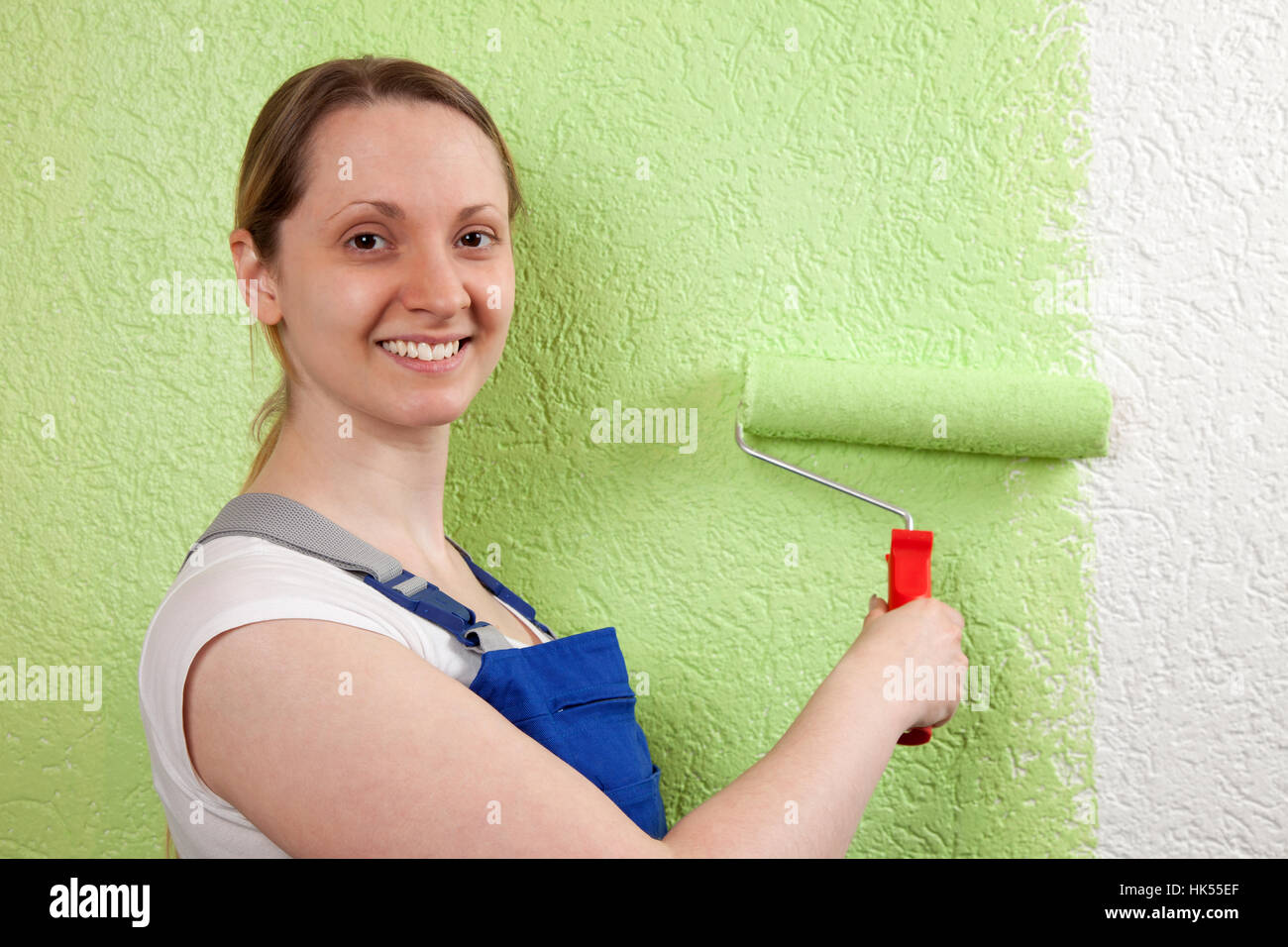 young woman with paint roller Stock Photo - Alamy