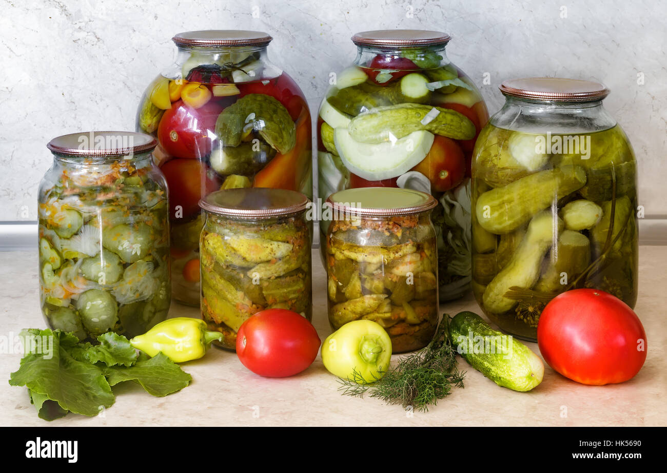 Home canning: large glass cylinders with a variety of vegetables ...