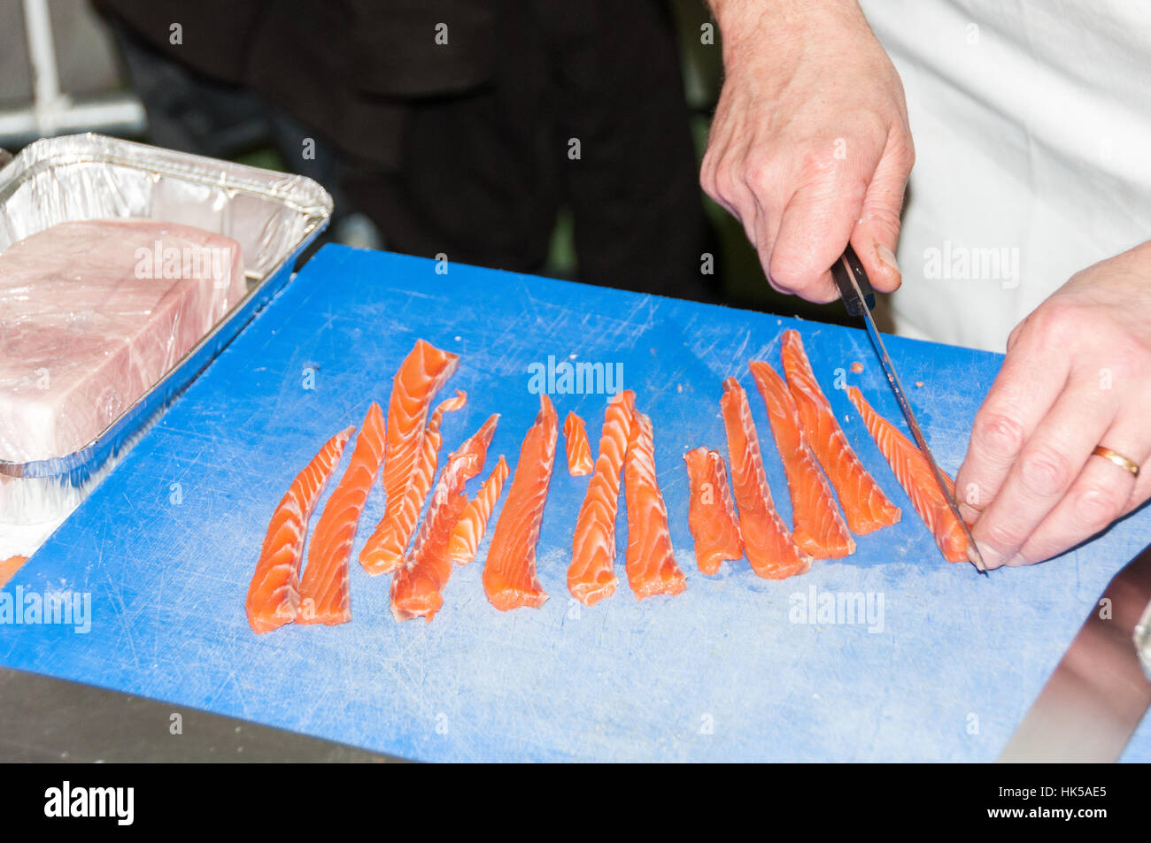 Chef cutting salmon fish with knife Stock Photo - Alamy