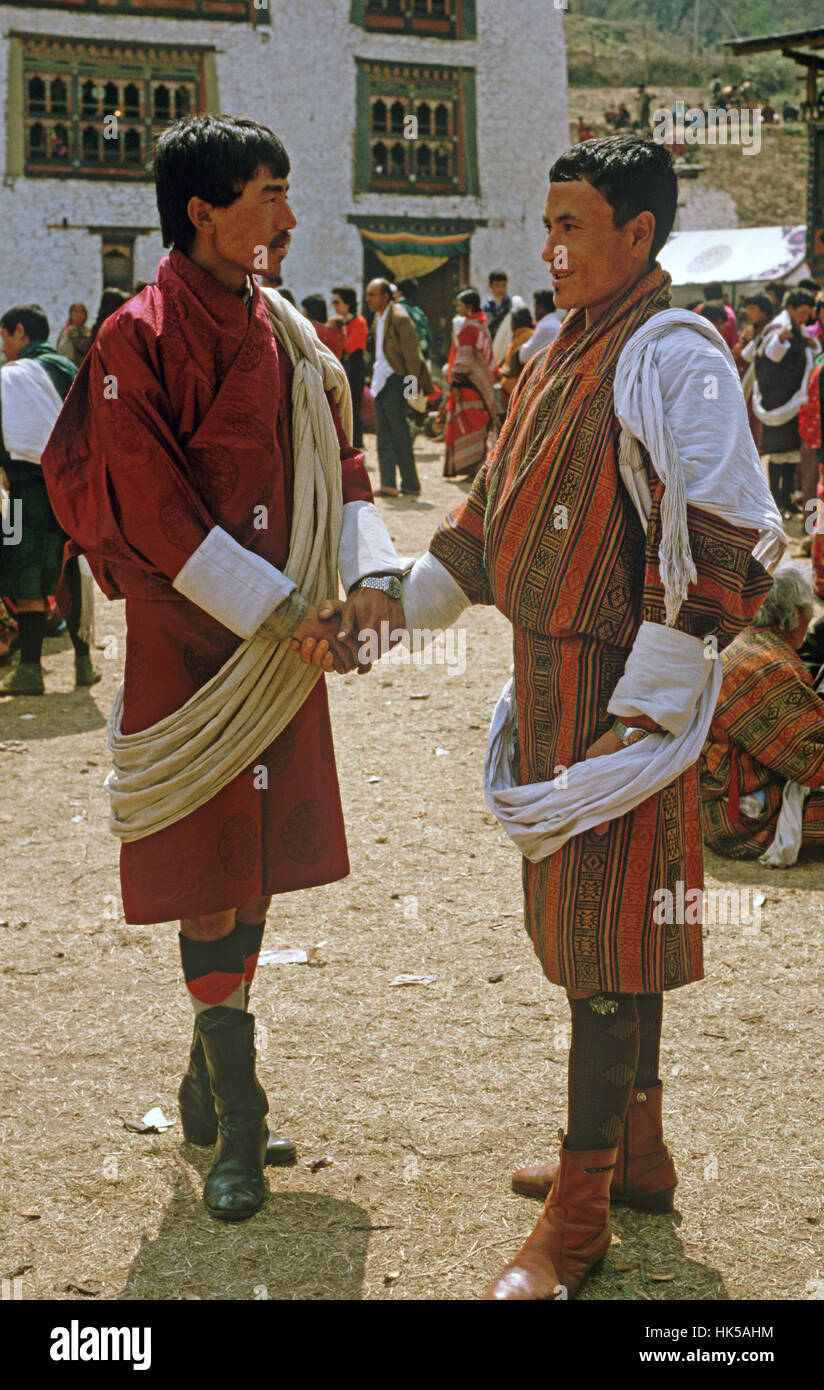 Bhutanese men in traditional costumes at at the Paro Tshechu, mask ...