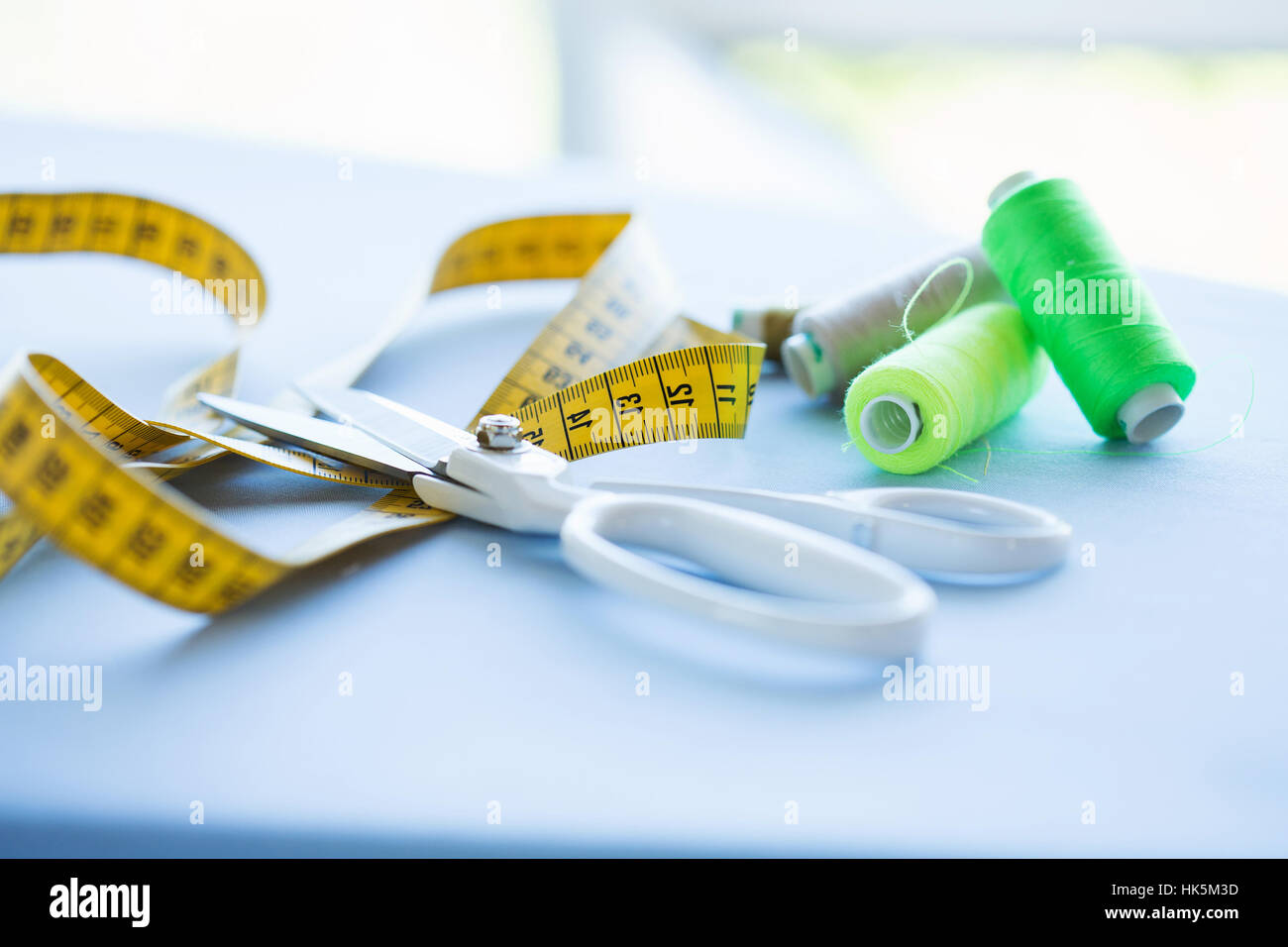 Scissors measuring tape and threads on table hi-res stock photography ...