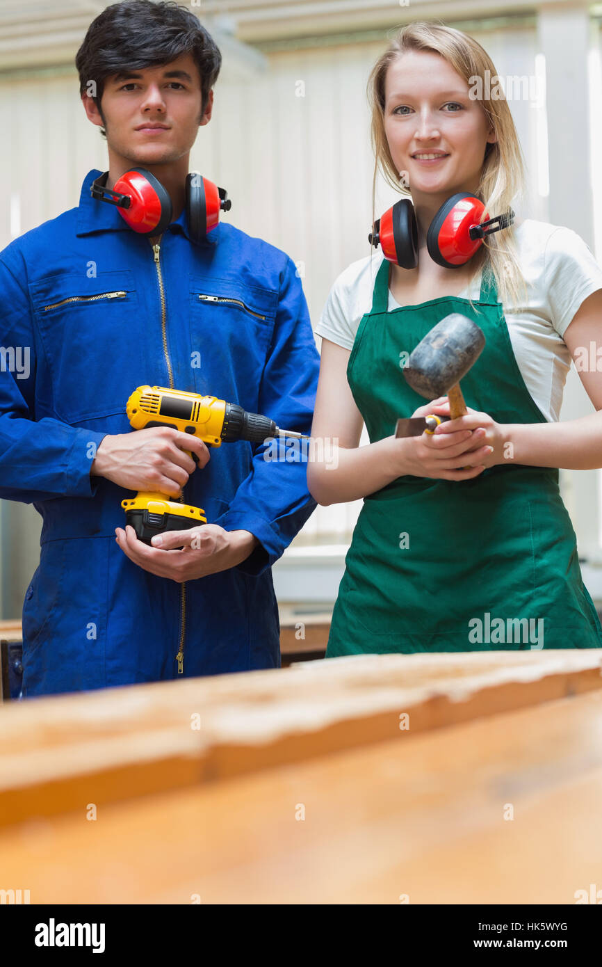 Young woman holding hammer drill hi-res stock photography and images ...