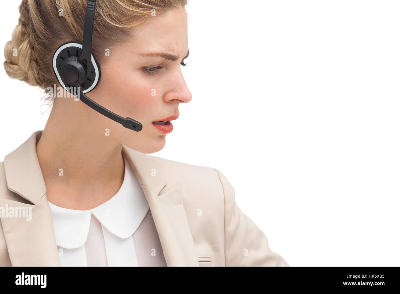 Annoyed call center agent with headset Stock Photo - Alamy