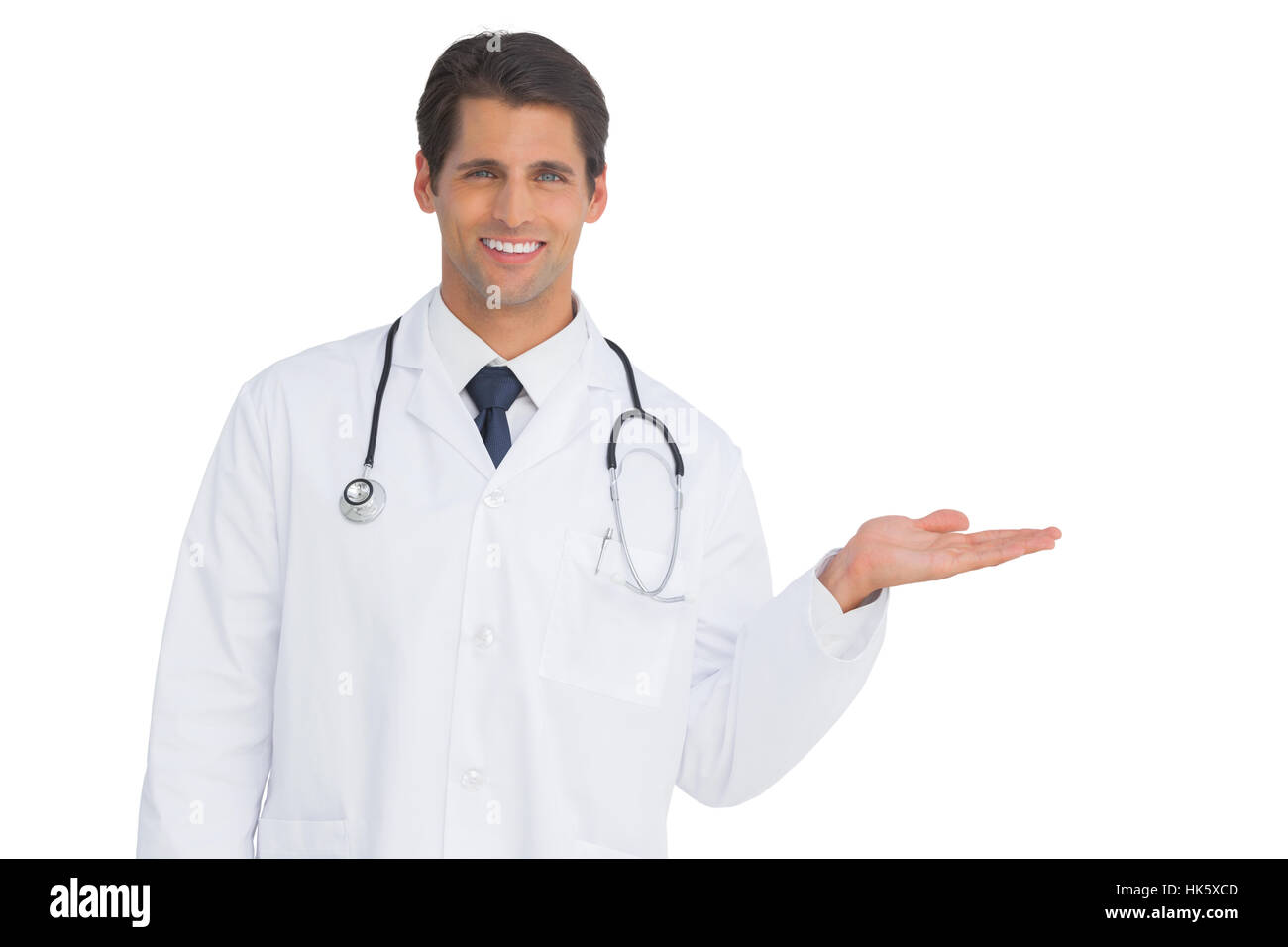 Happy doctor showing something and smiling on white background Stock ...