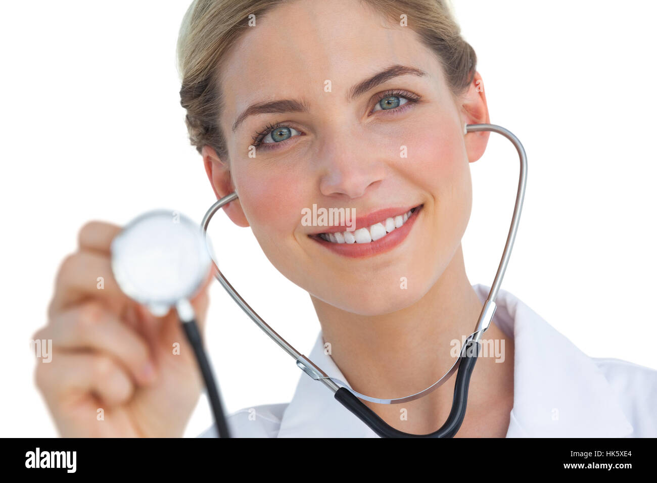 A smiling nurse using stethoscope on white background Stock Photo - Alamy