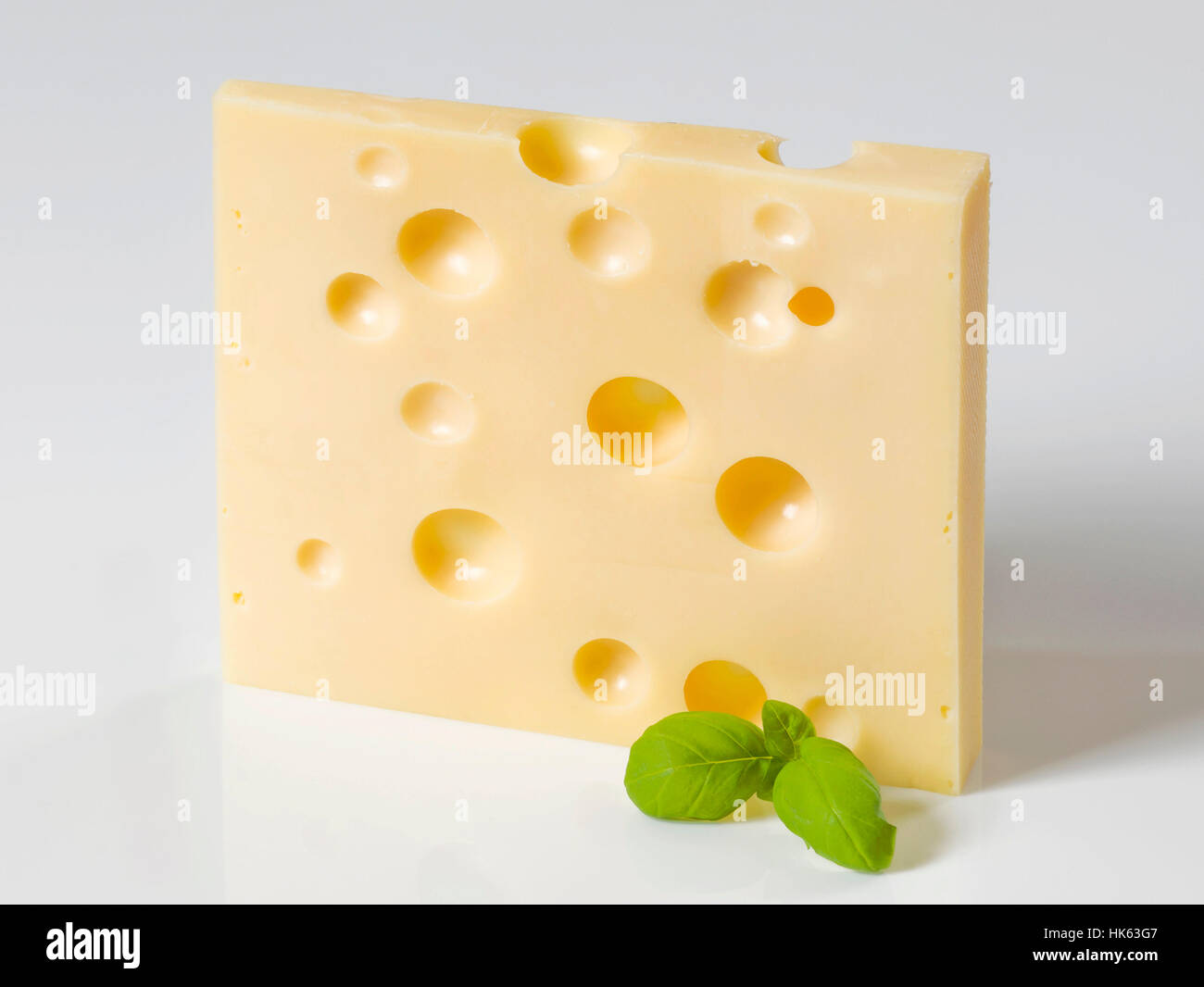 Slice of Swiss cheese Stock Photo - Alamy