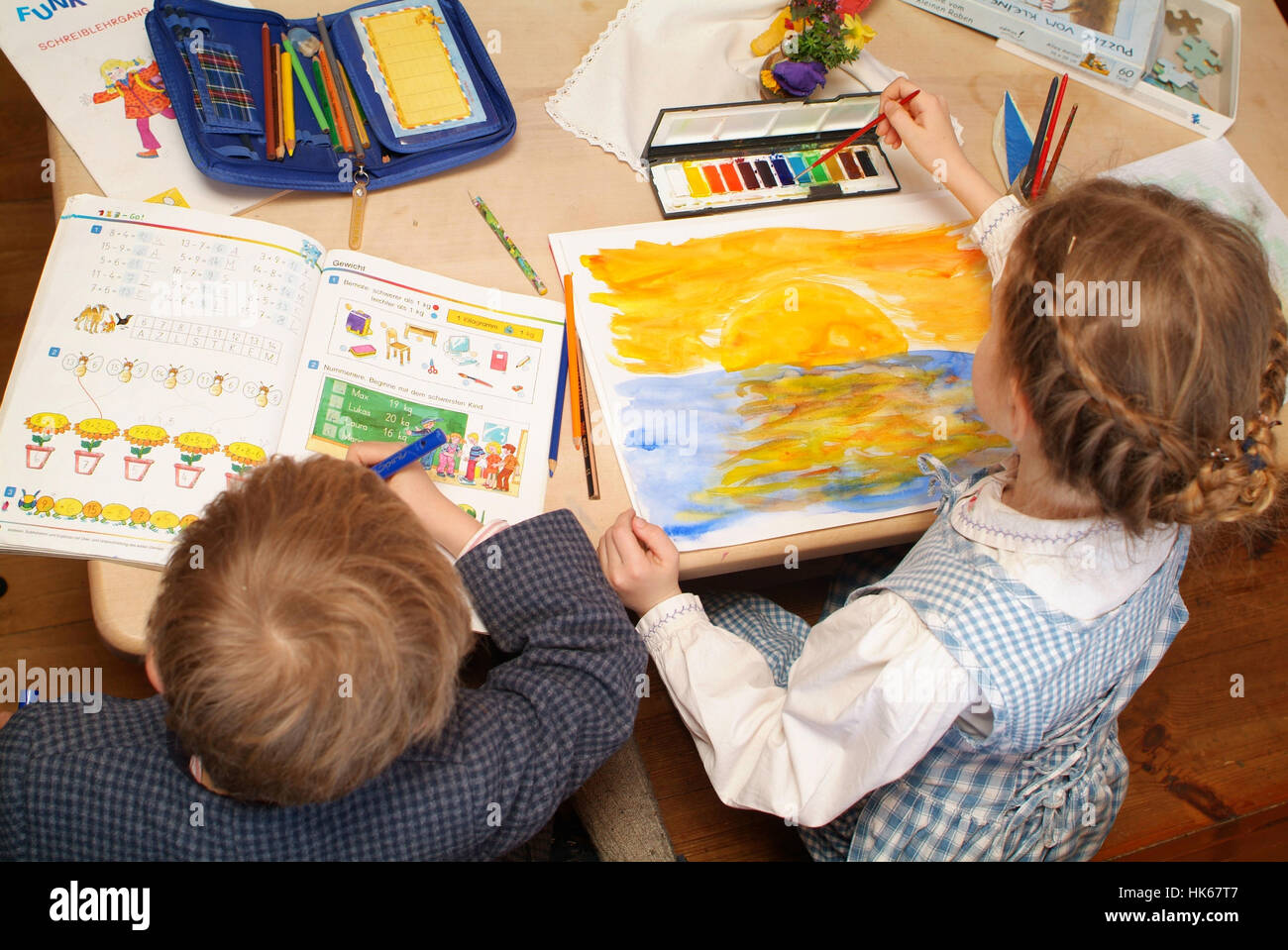 Children at home painting and doing homework Stock Photo - Alamy