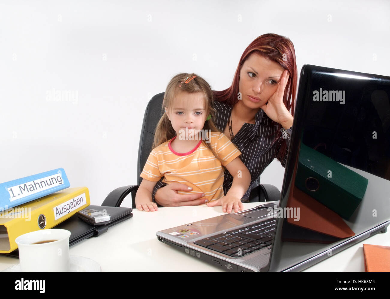 Stressed mother with child at work Stock Photo - Alamy