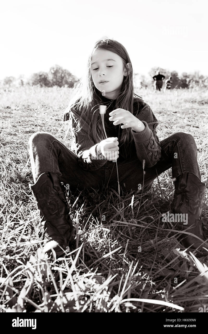 Girl sitting on grass Stock Photo - Alamy
