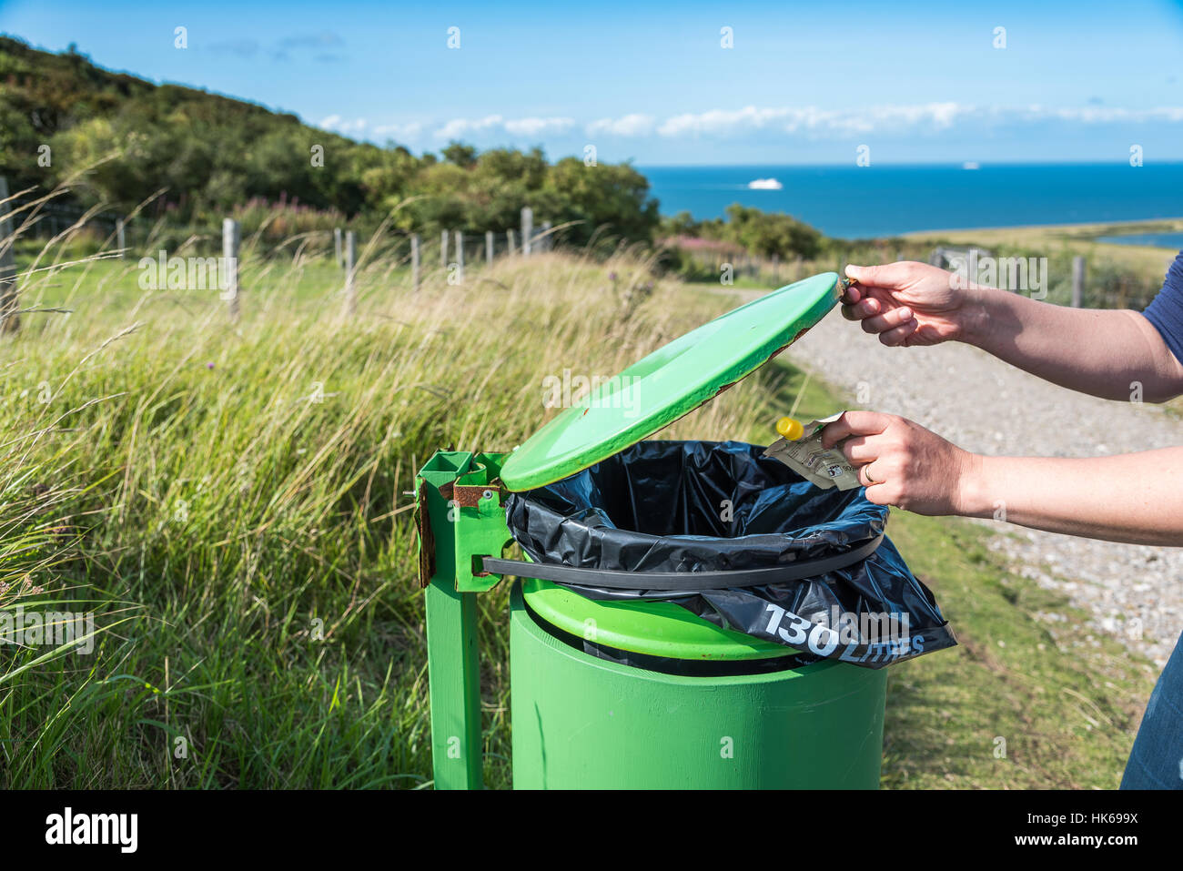 Woman throwing packing in trash cans Stock Photo - Alamy