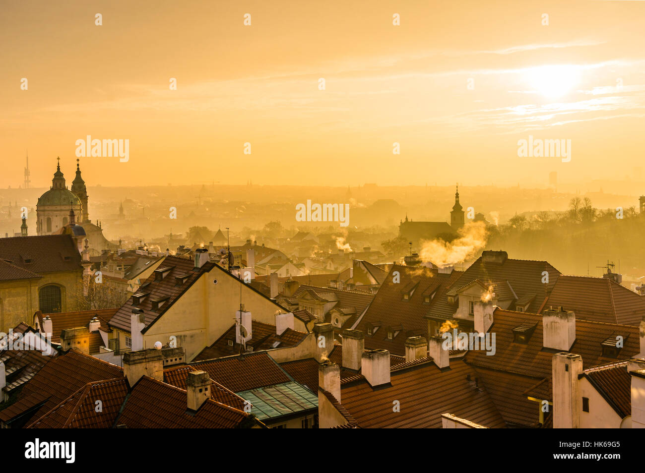 Morning atmosphere, roofs with smoking chimneys in fog, sunrise ...