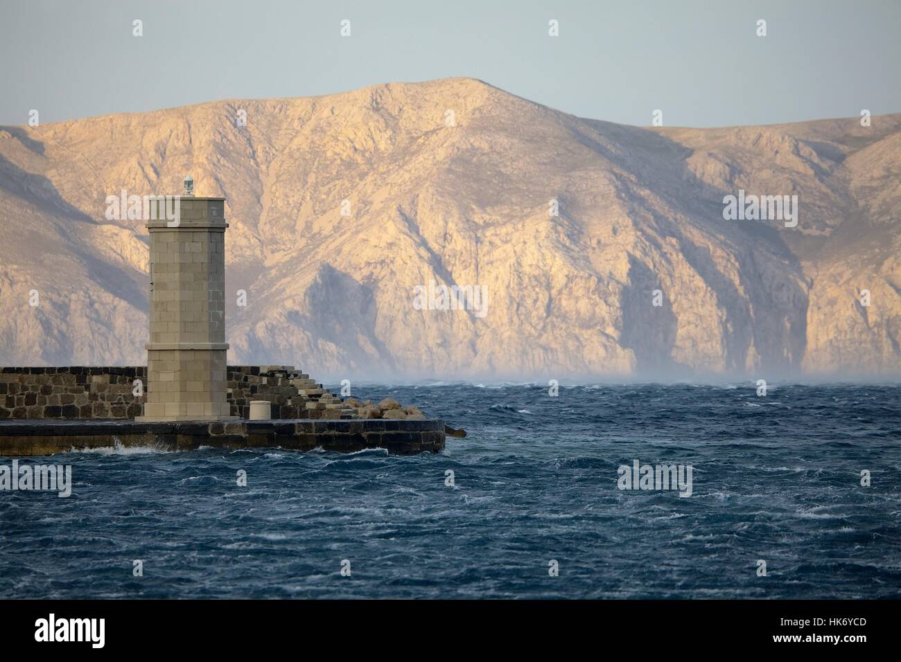 Lighthouse of a small dock with waving sea Stock Photo - Alamy