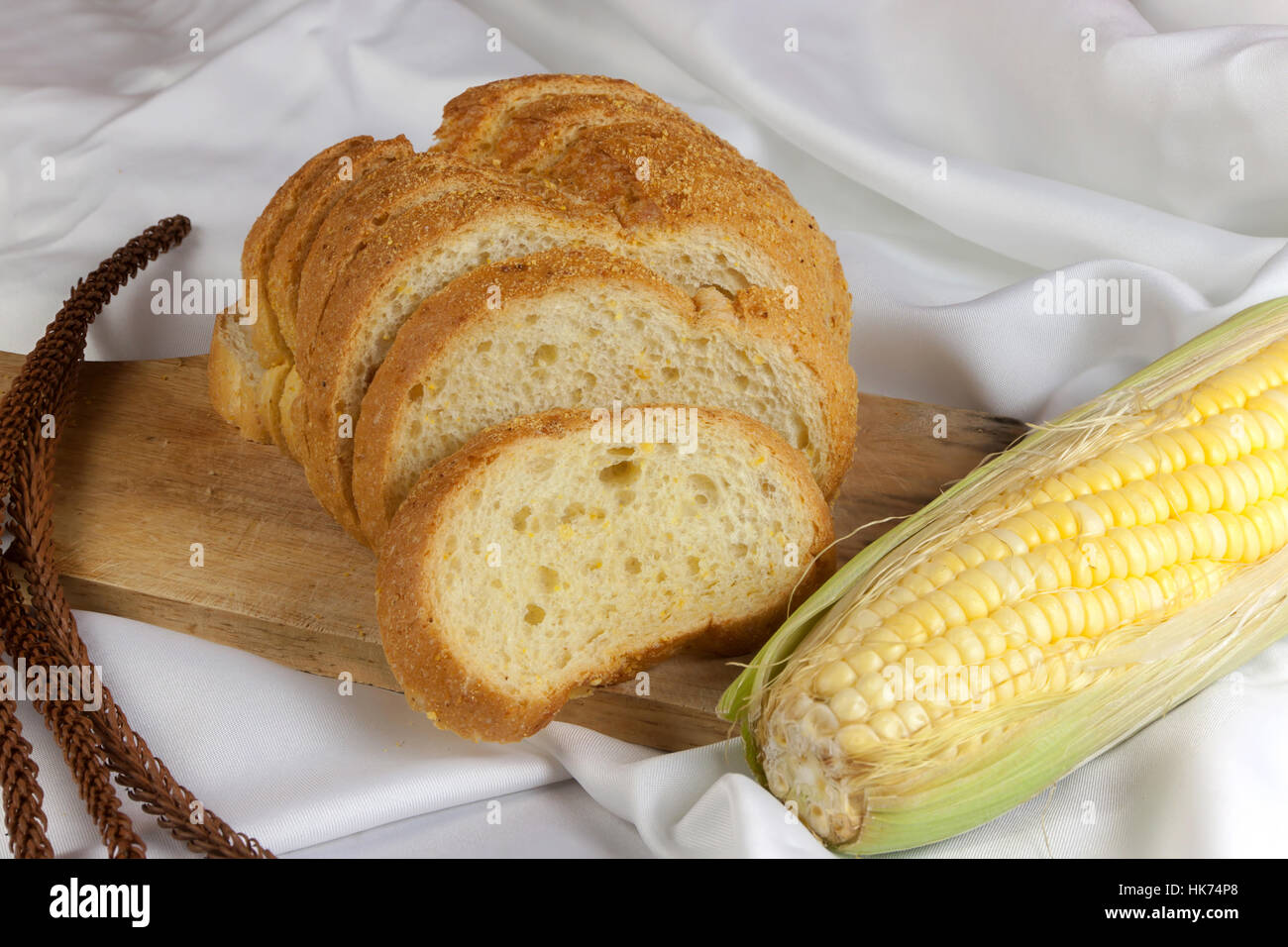 bread made from corn on the white fabric. Slices of corn bread laying ...
