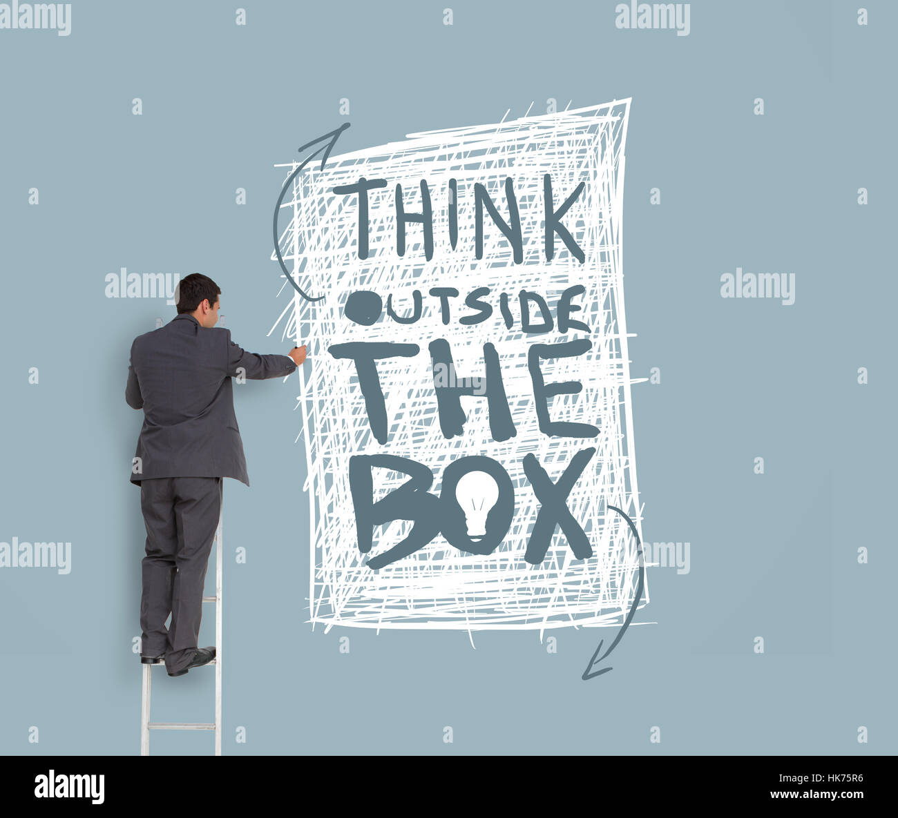 Businessman drawing think outside the box message on grey wall Stock ...