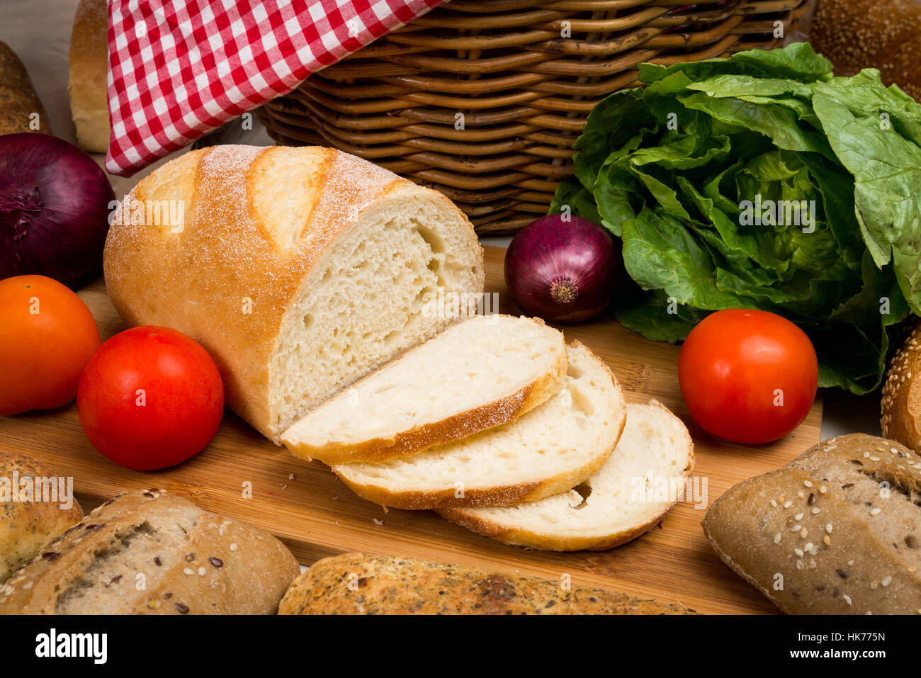 Picnic spread with fresh sliced bread bread rolls red Spanish onion ...