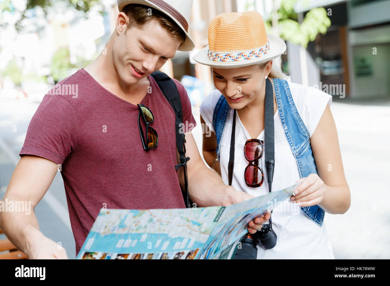 Smiling tourists map holding hi-res stock photography and images - Alamy
