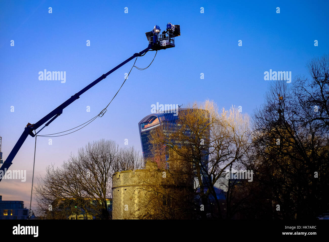 A crane hoists a lighting rig over the Tower of London as part of ...