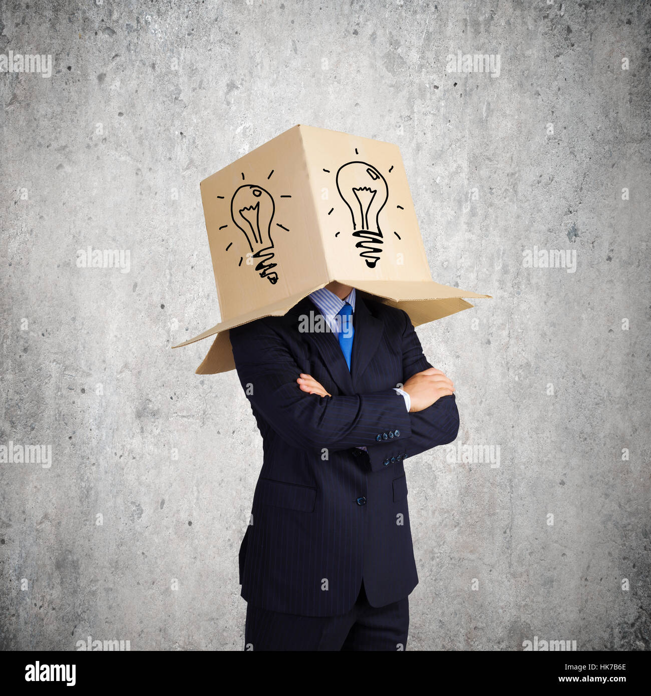 Businessman wearing on head carton box with drawing of bulb hi-res ...