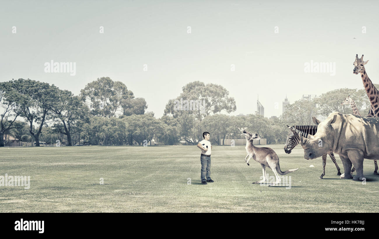 Boy of school age outdoor with wild animals Stock Photo - Alamy