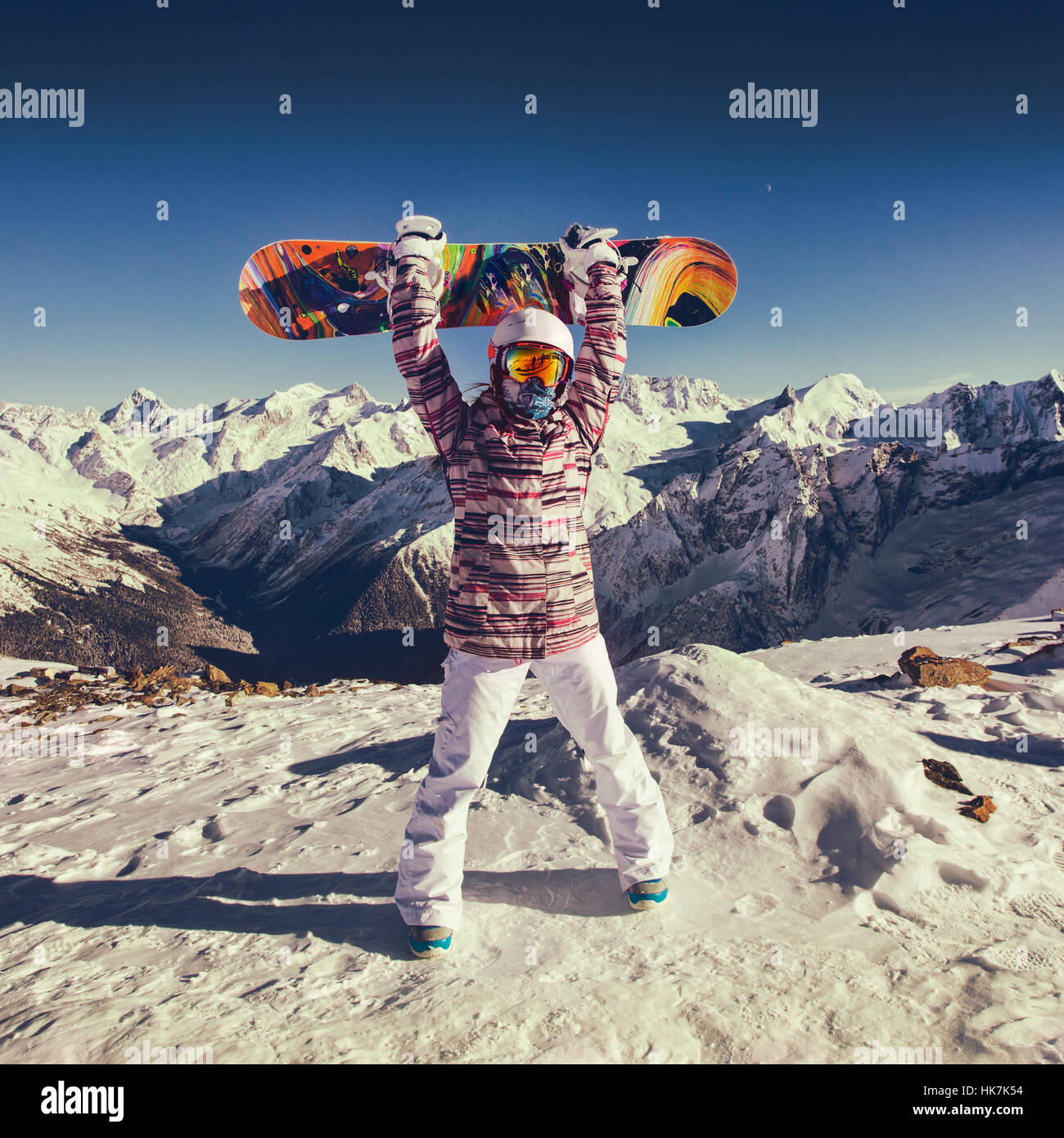 Female snowboarder in the alpine mountains Stock Photo - Alamy