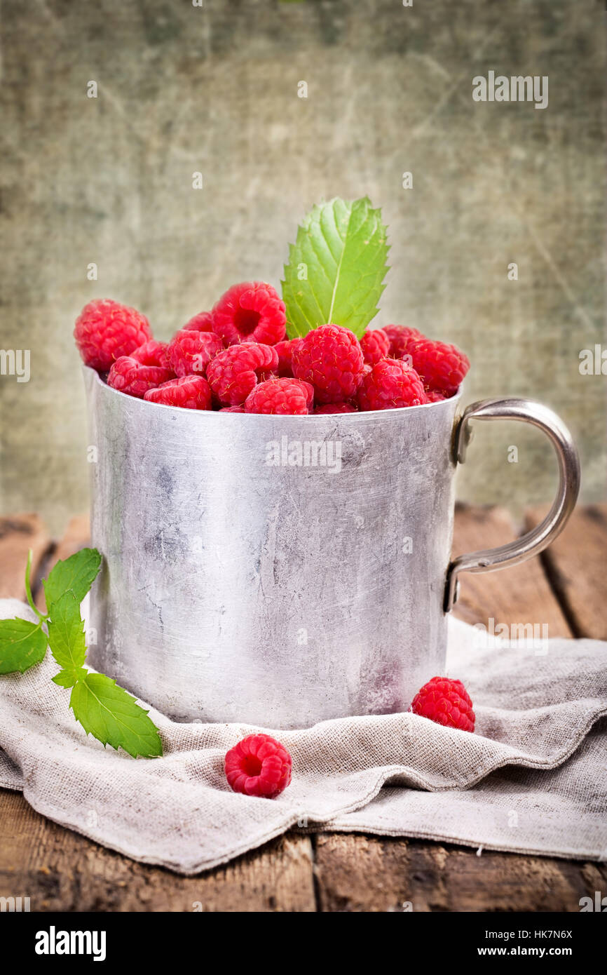 freshly picked raspberries with rustic background Stock Photo - Alamy