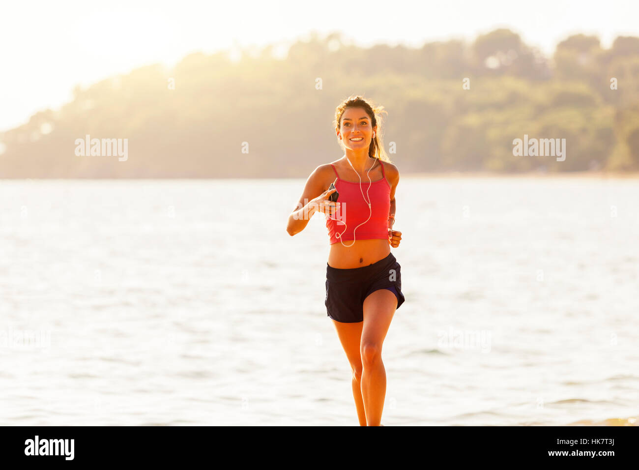 Woman running beach beach hi-res stock photography and images - Alamy