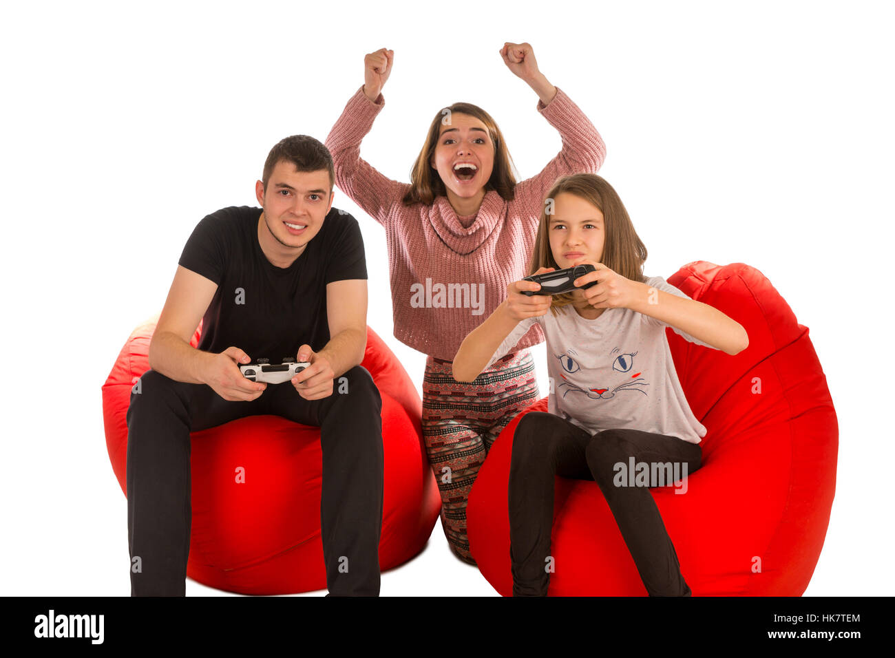 Young happy people are enthusiastic about playing video games while ...