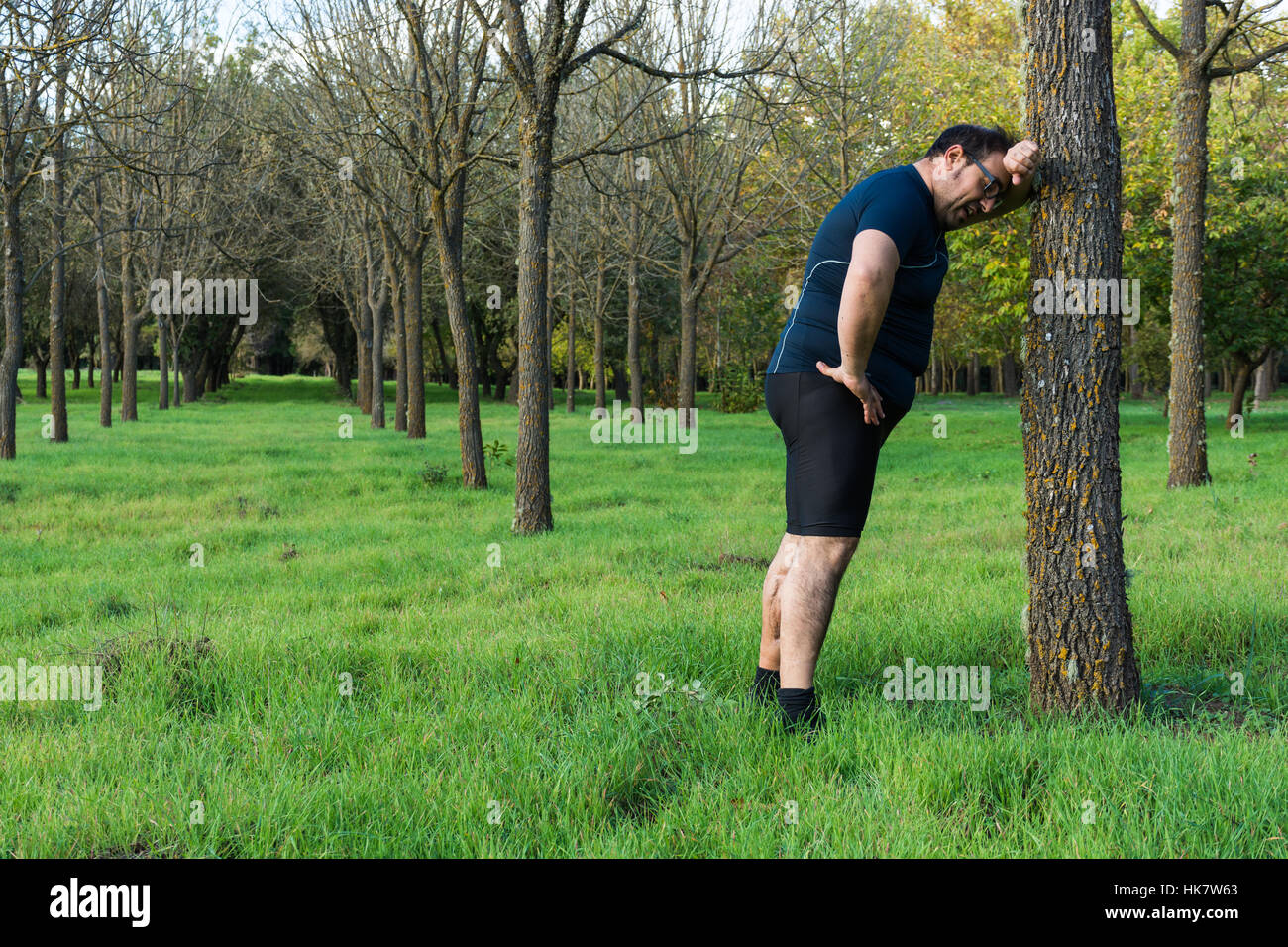 Abstract and conceptual tired, tired man in the woods. Man weighed down ...