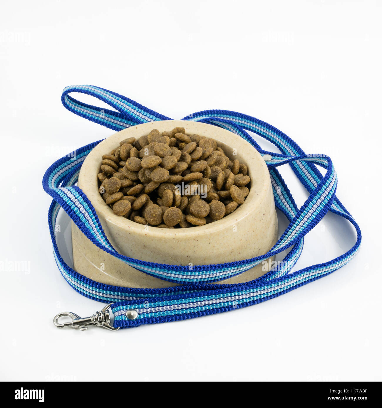 The close up of kibbles (dog food) in brown plastic dog bowl and blue ...