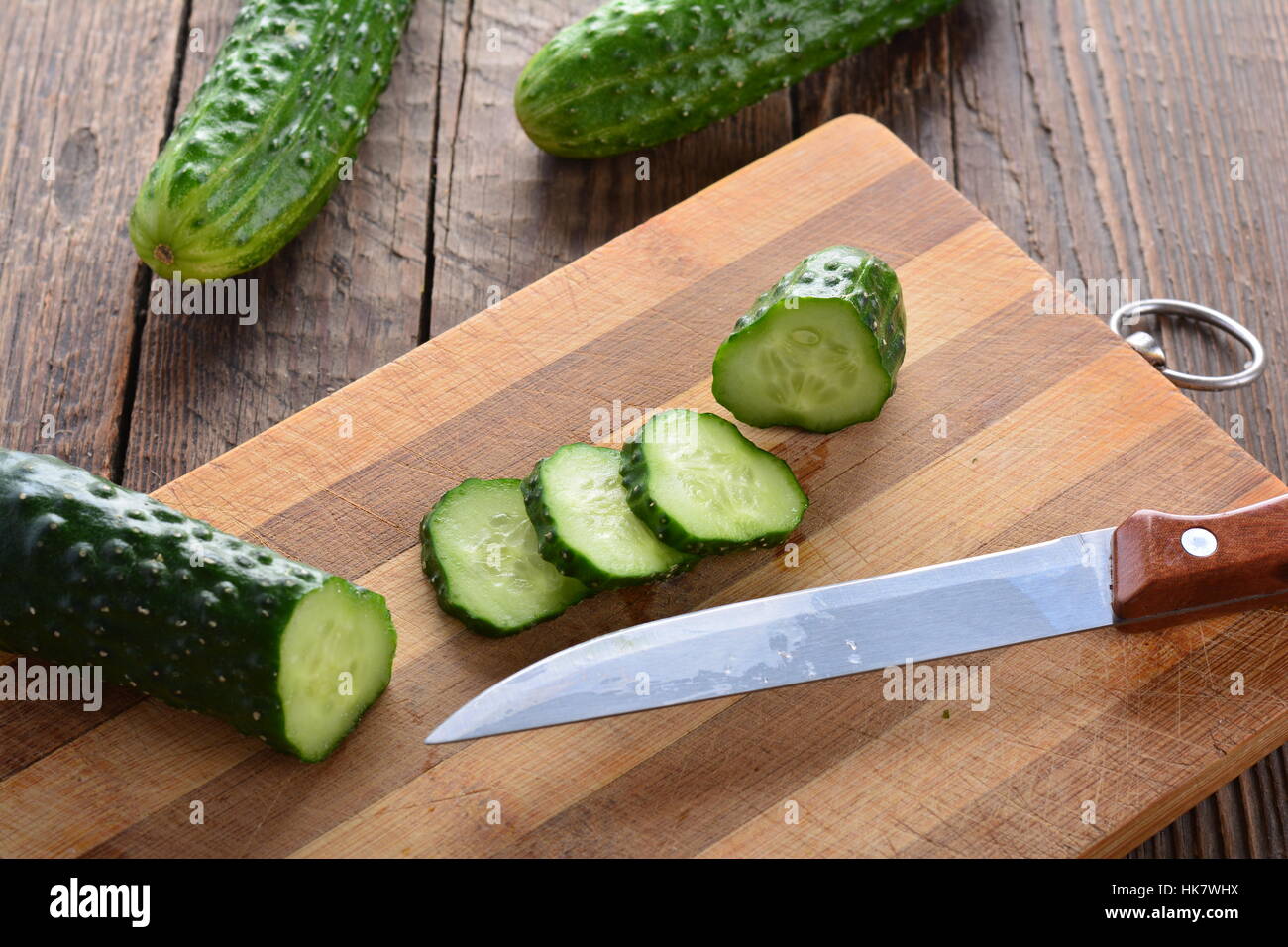 Woman cut cucumber knife hi-res stock photography and images - Alamy