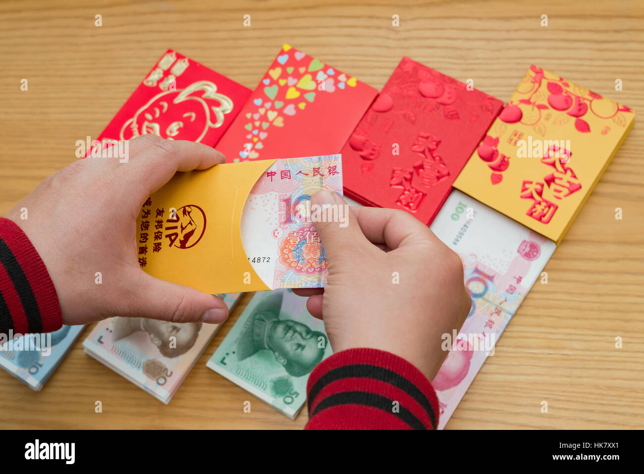 Zhongshan,China-Jan 26,2017:man preparing a red pocket for Chinese new ...