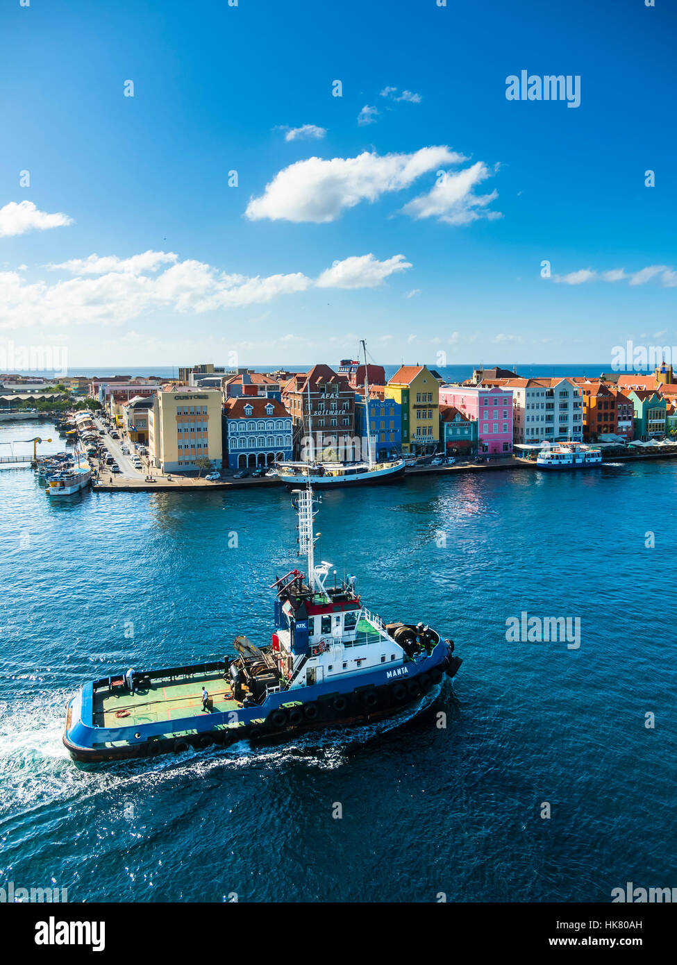 Tugboat, colorful row of houses in Punda district at back, commercial ...