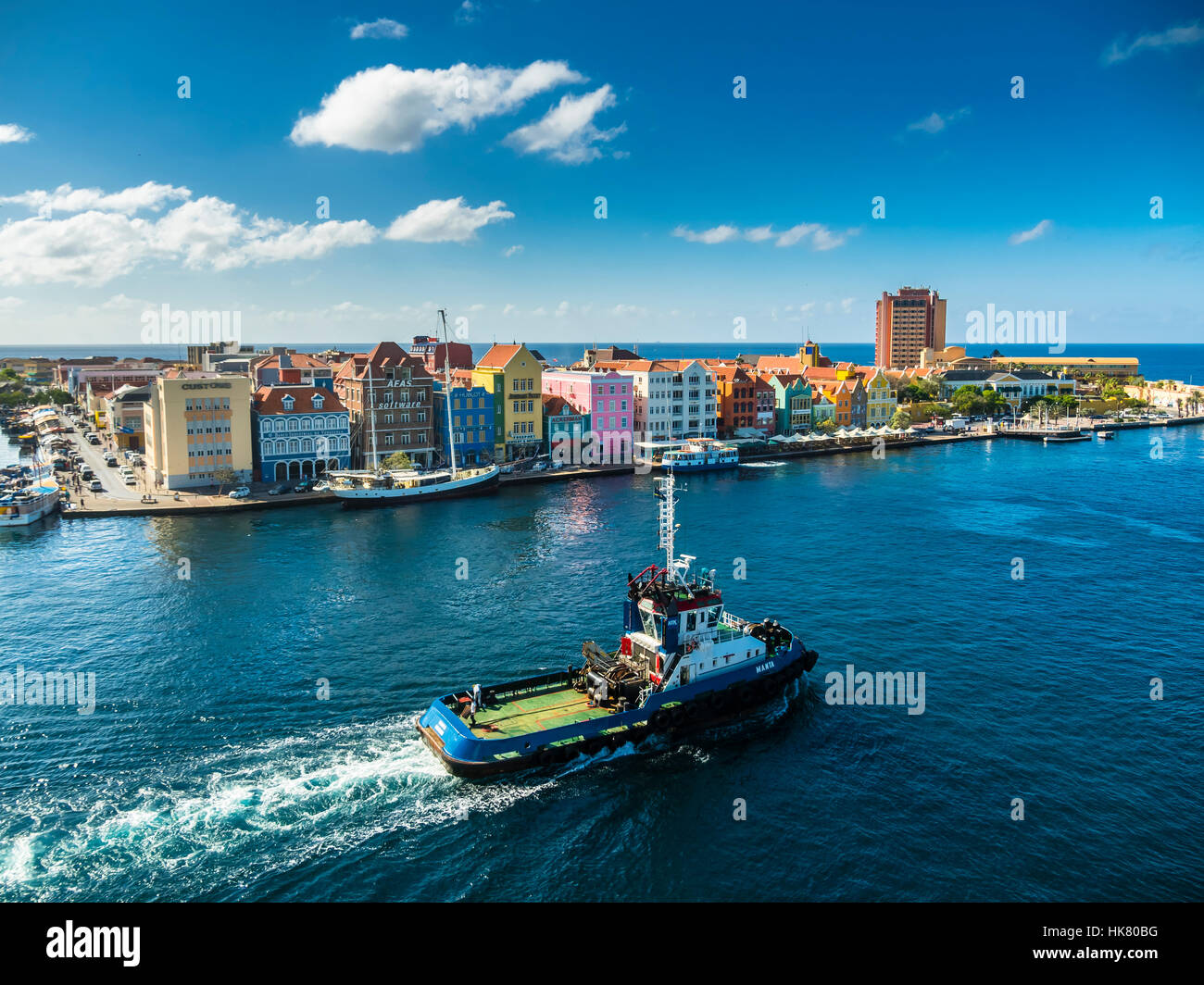 Tugboat, colorful row of houses in Punda district at back, commercial ...