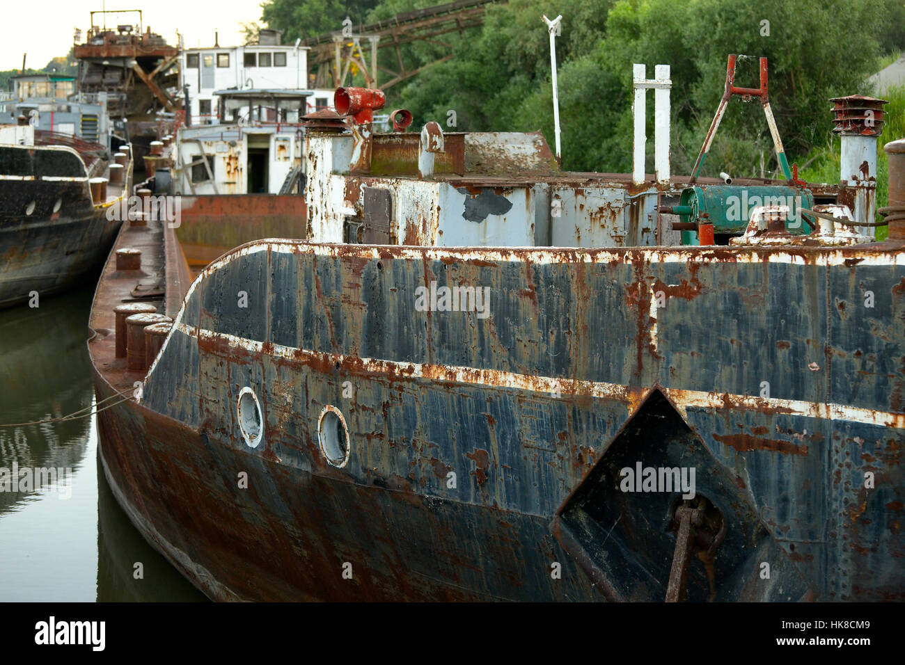 Old rusty shipwrecks on a river Stock Photo - Alamy