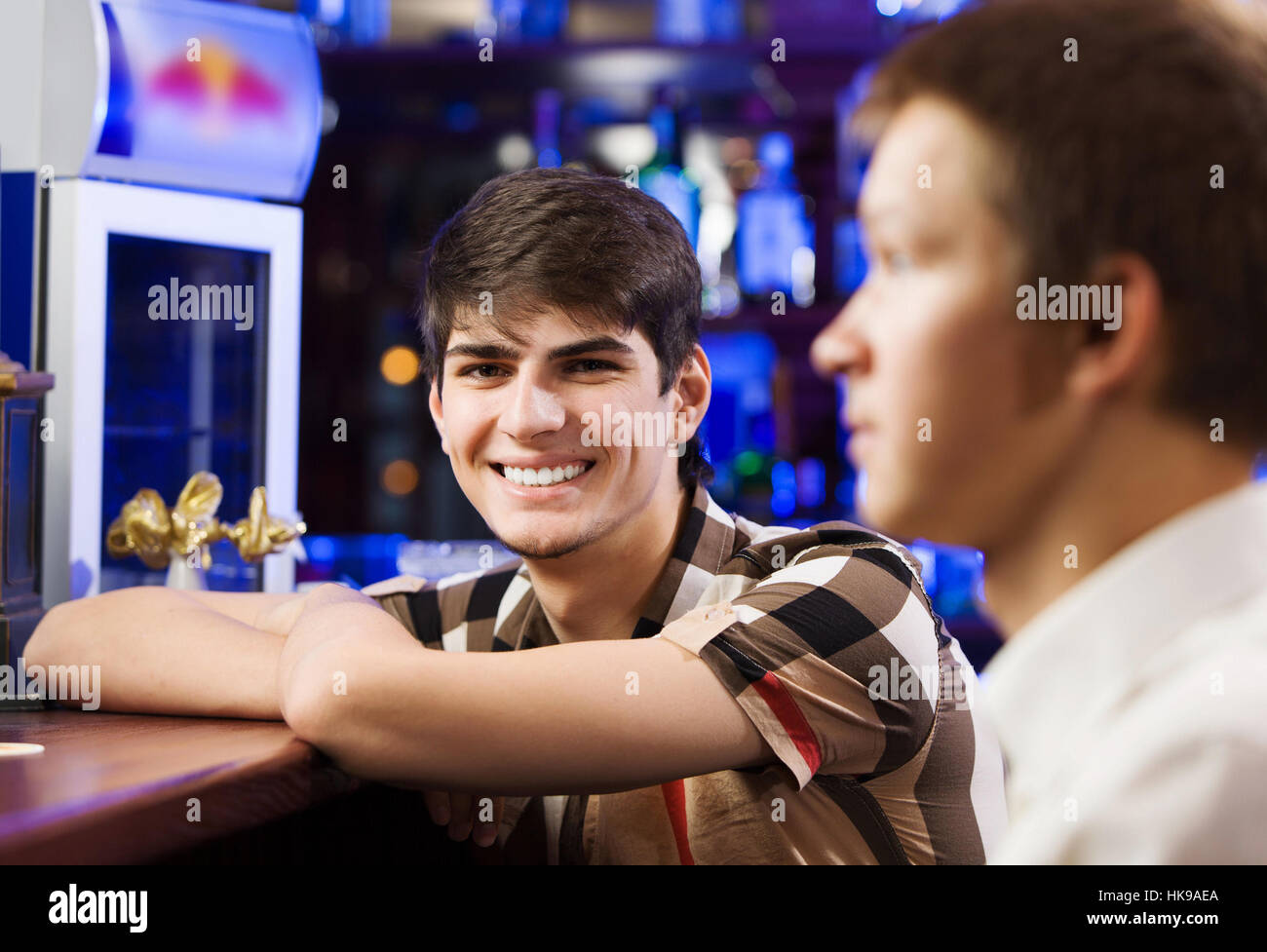Young men sitting bar hi-res stock photography and images - Alamy