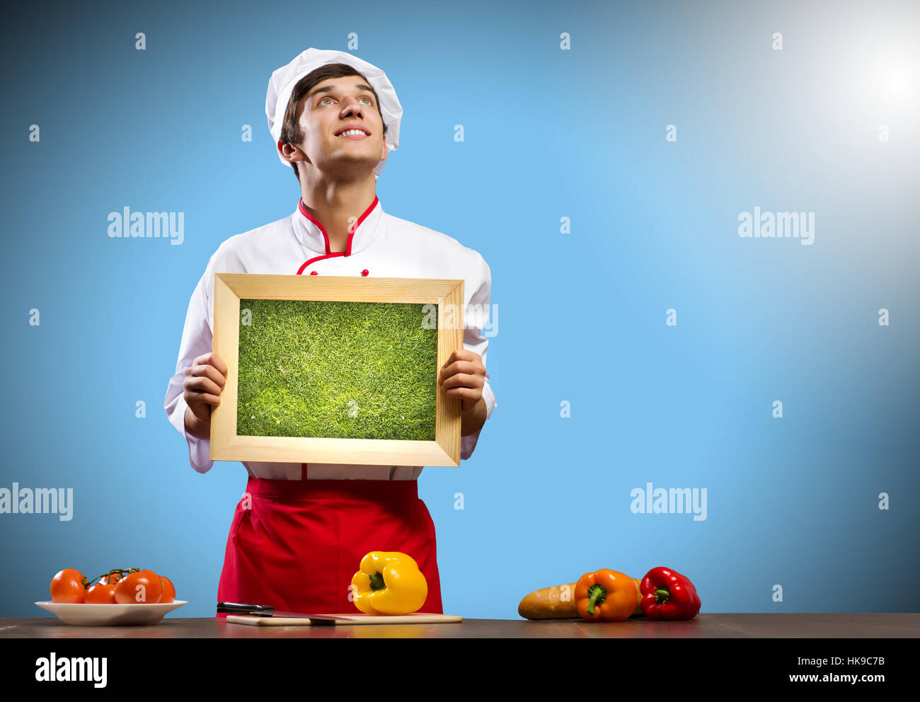 Handsome cook holding photo frame. Place for text Stock Photo - Alamy