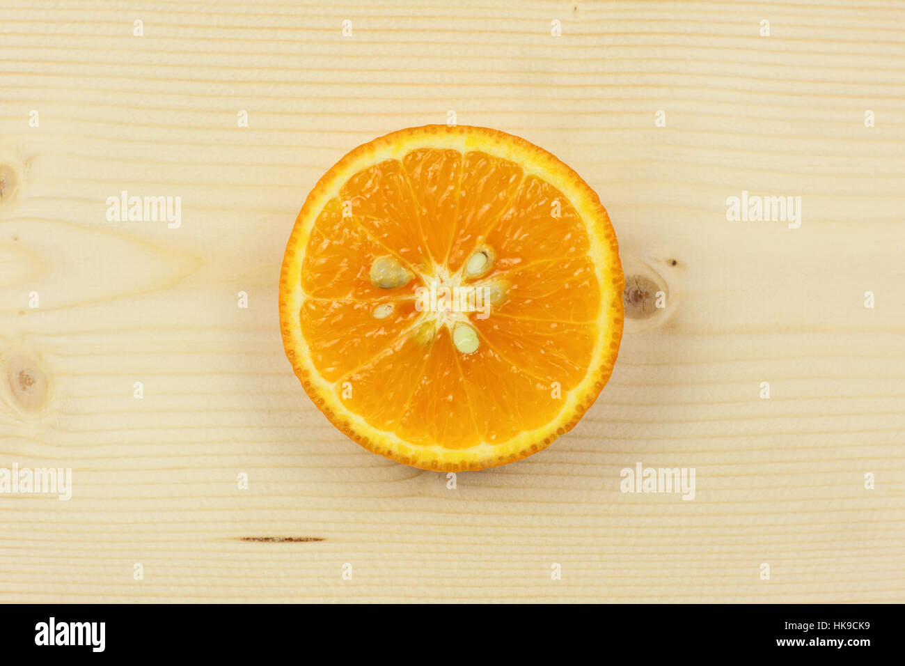 Orange slice close up in studio over wooden background Stock Photo - Alamy