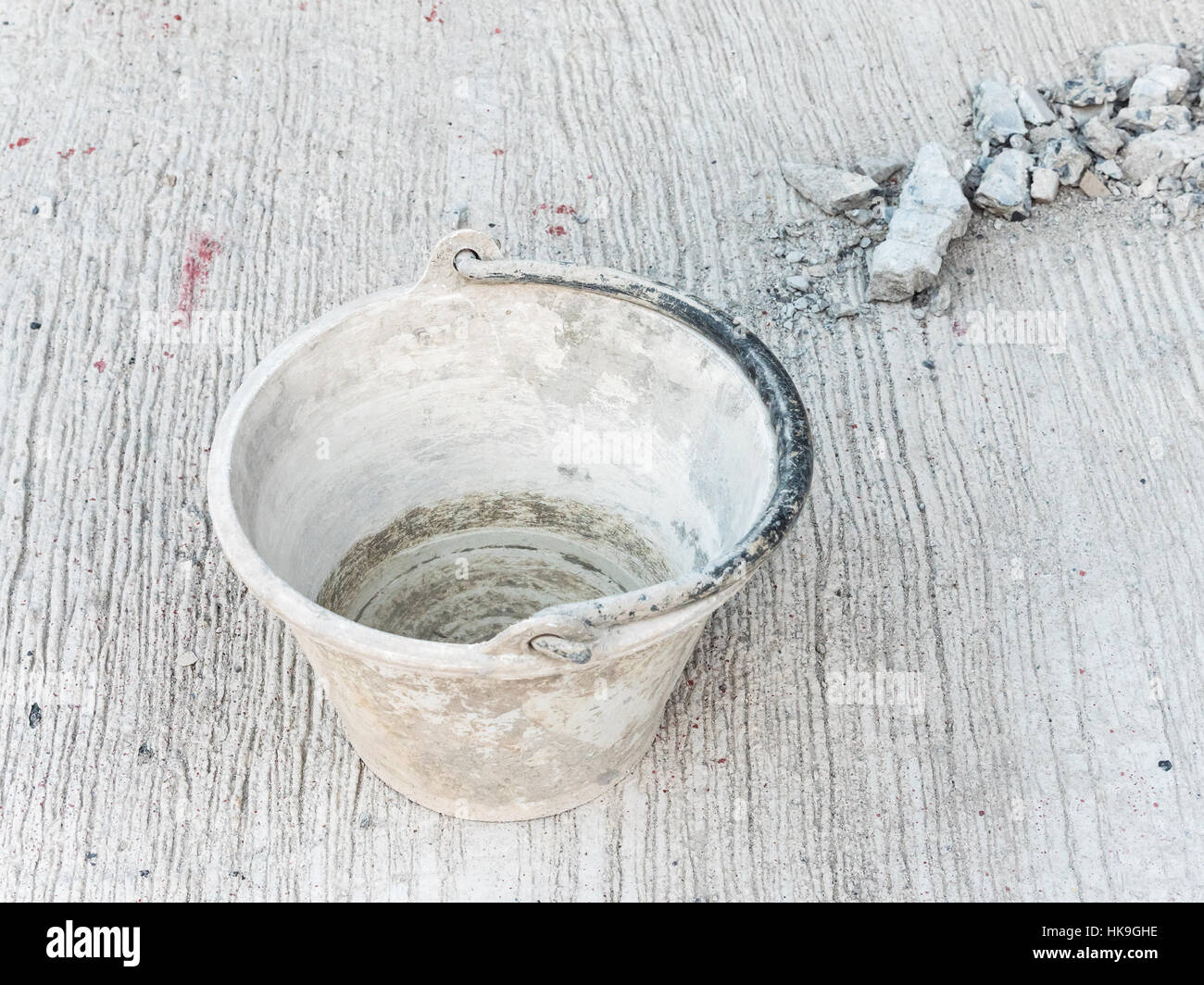 Dirty plastic bucket on the cement floor of the construction site Stock ...
