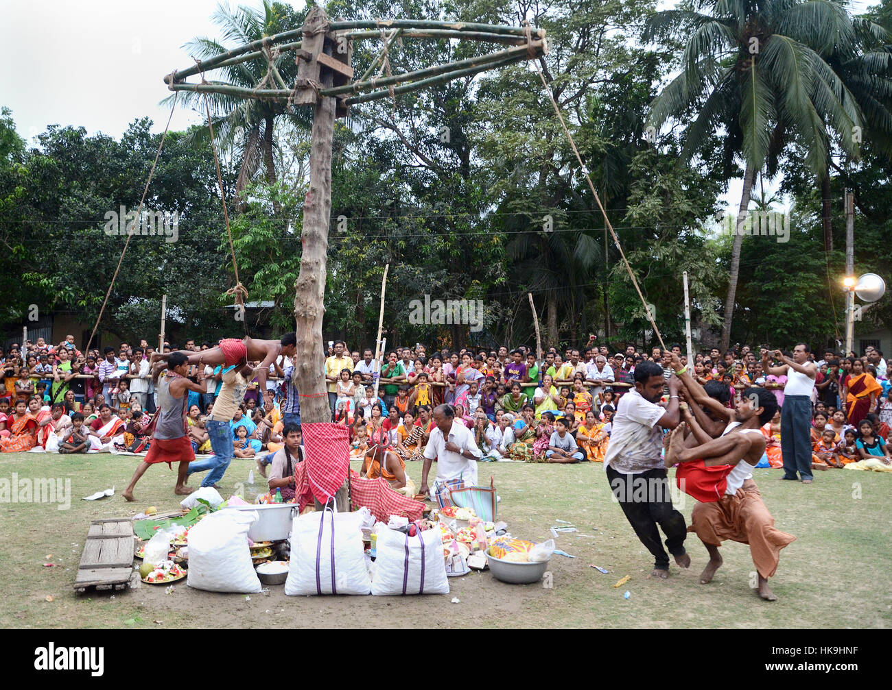 Devotees hanging rope with hooks on back, charak pooja, west bengal ...
