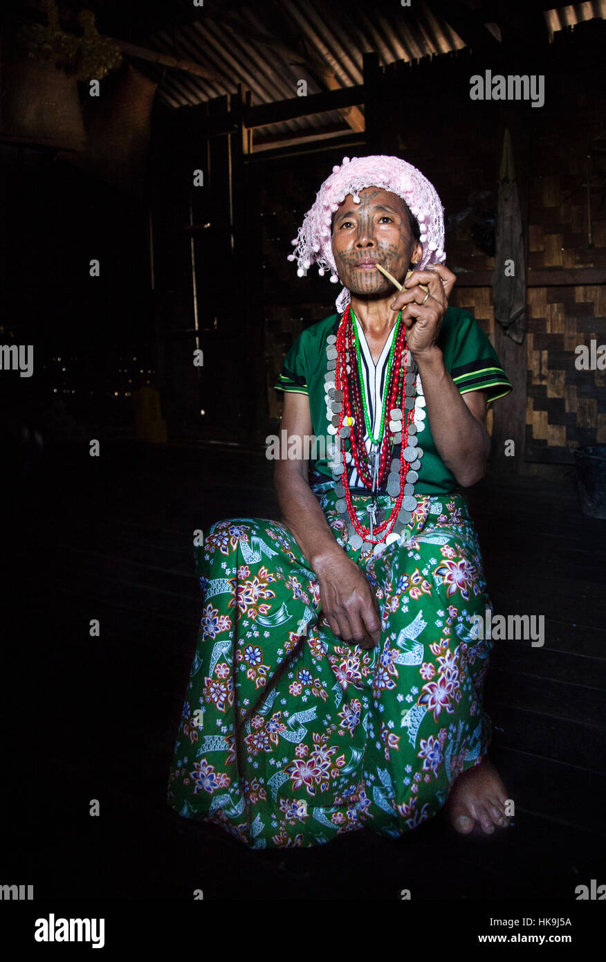 Chin region, Myanmar, November 11, 2014: muun tribe chin lady smoking a ...