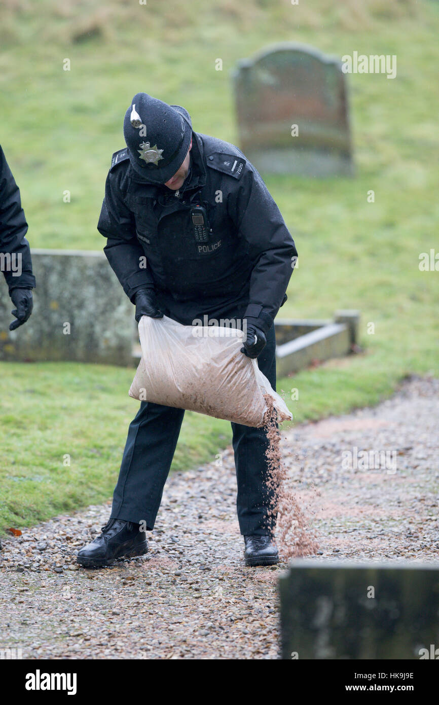 Police put down grit on an icy church path to defrost it Stock Photo ...