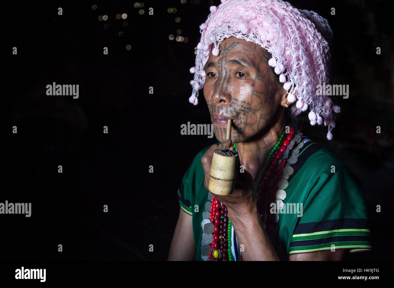 Chin region, Myanmar, November 11, 2014: muun tribe chin lady smoking a ...