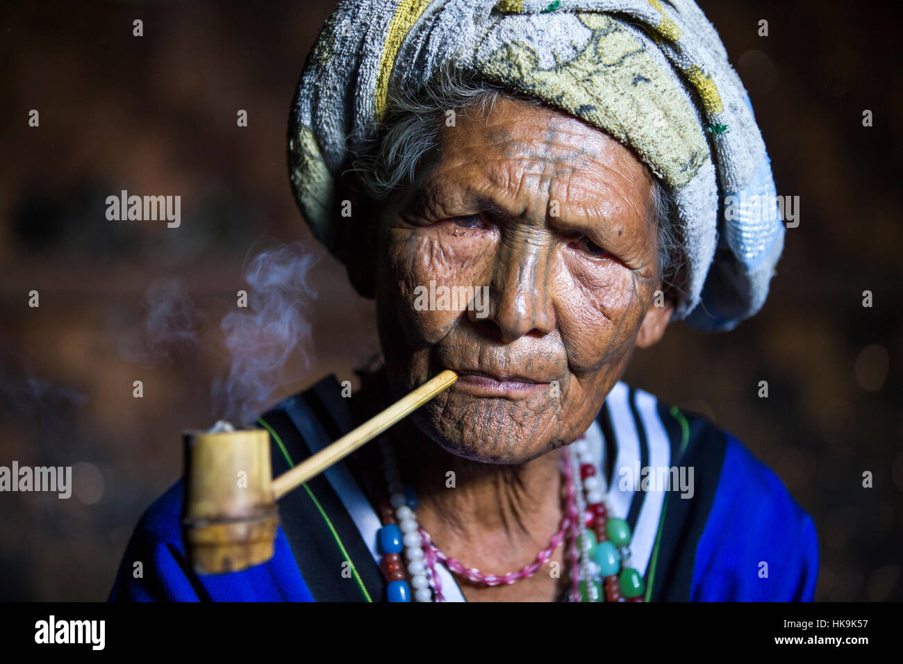 Chin region, Myanmar, November 11, 2014: muun tribe chin lady smoking a ...