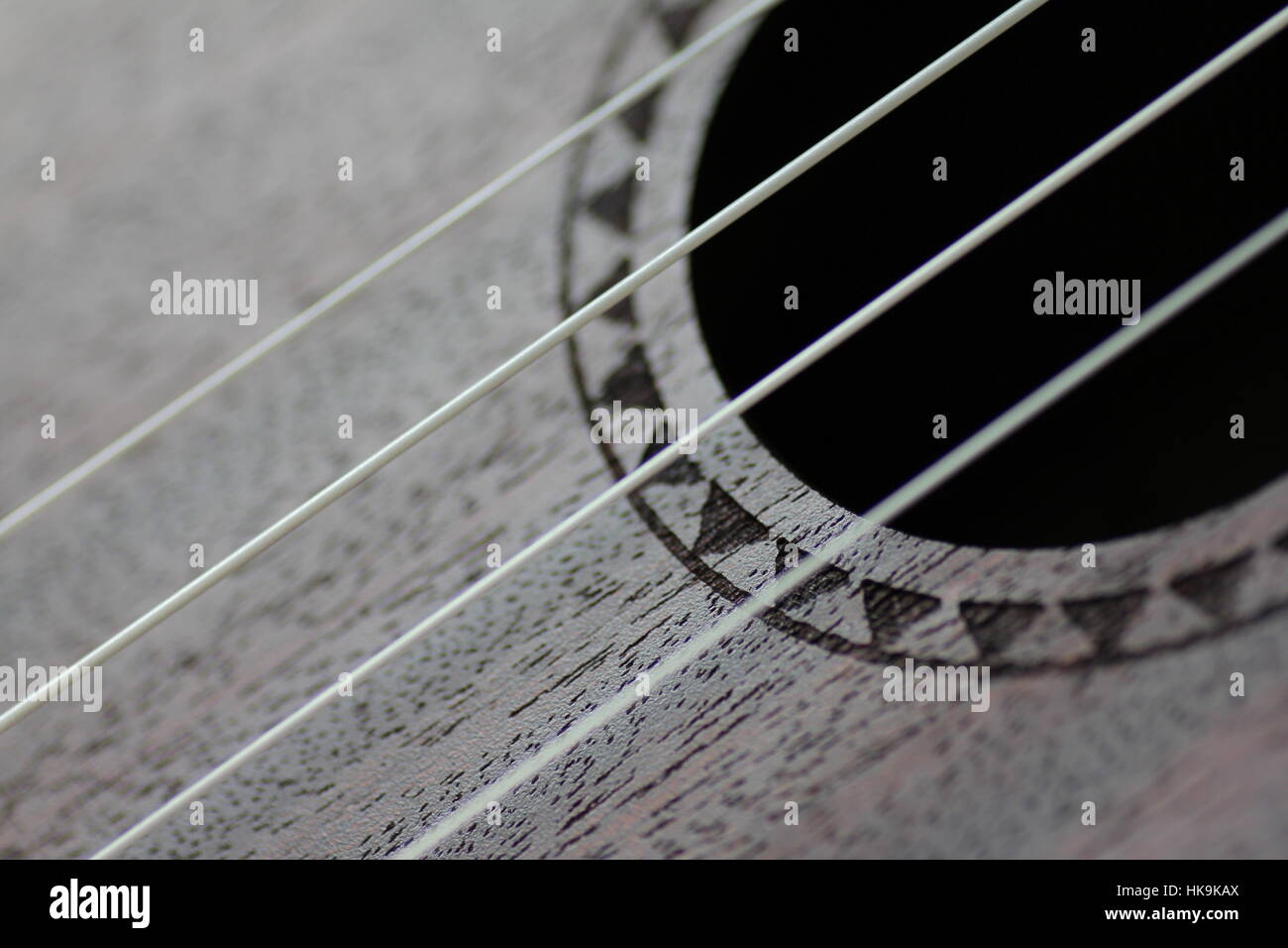 Ukulele sound hole and strings Stock Photo - Alamy